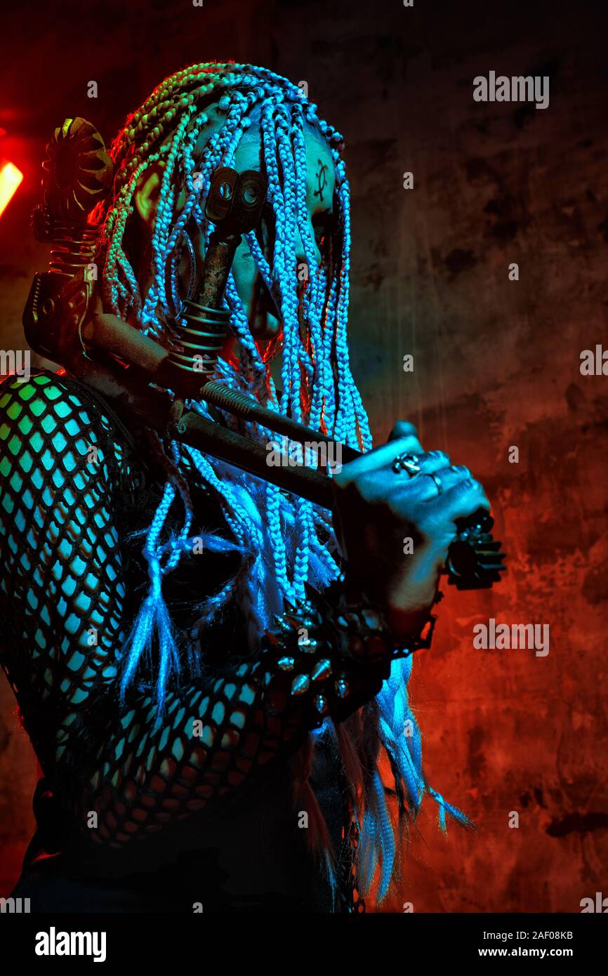 brutal girl with dreadlocks and wrench with creative make up. Halloween ...