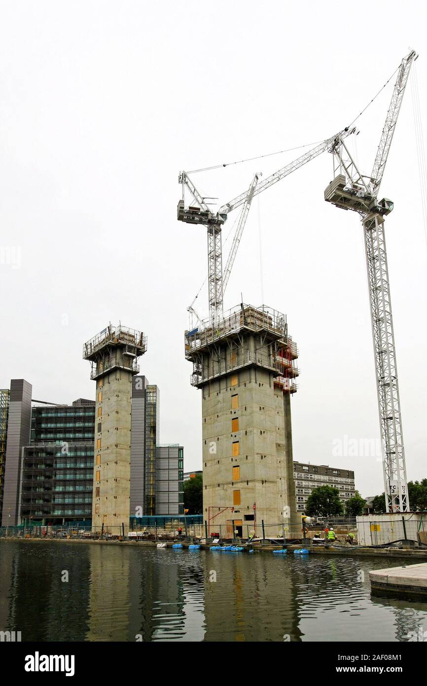 Construction site with concrete towers at river bank Stock Photo - Alamy