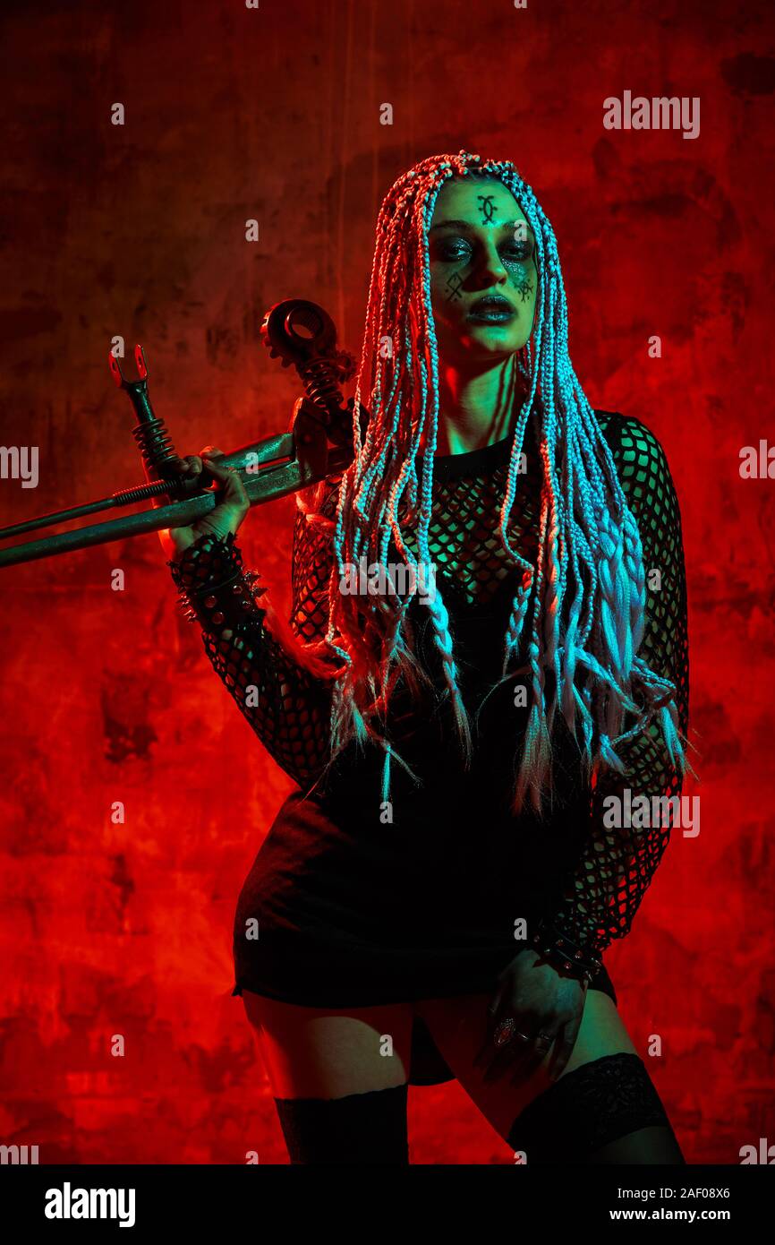 brutal girl with dreadlocks and wrench with creative make up. Halloween ...