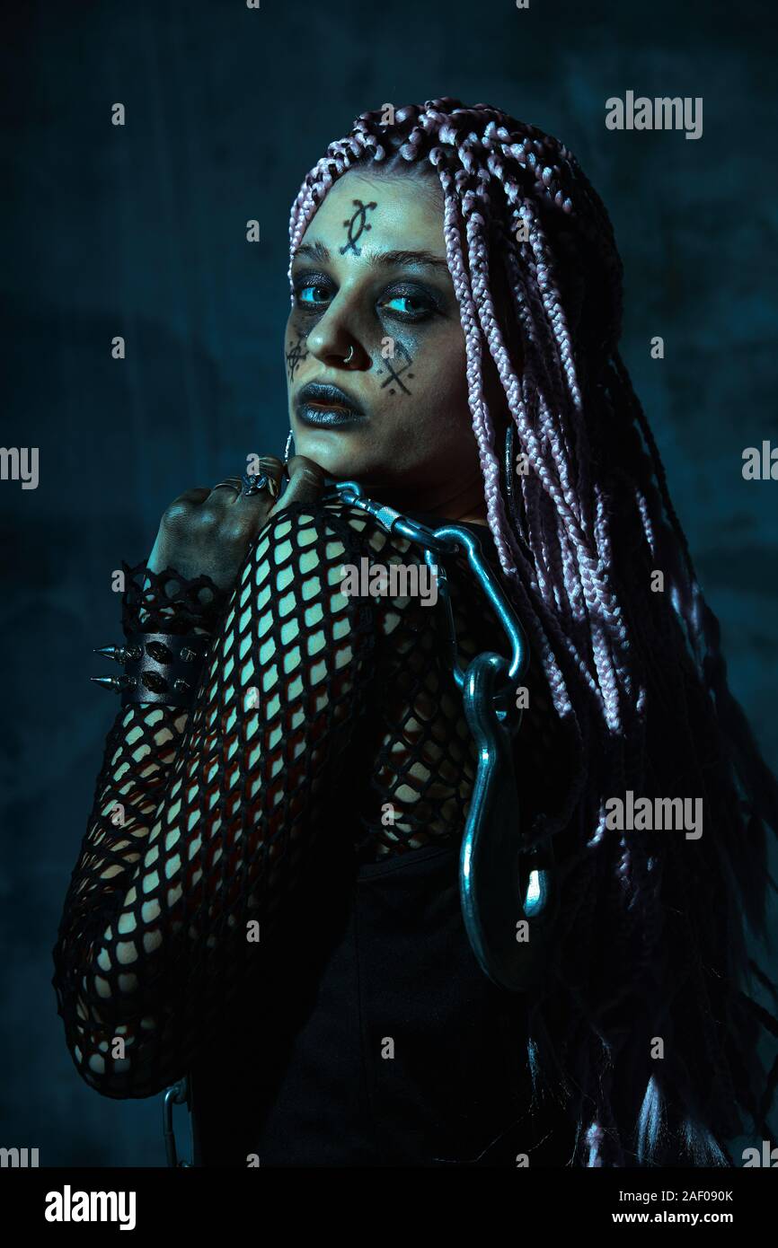 brutal girl with dreadlocks and wrench with creative make up. Halloween ...