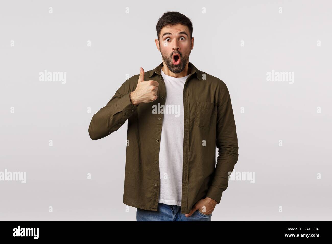 Impressed man fascinated with friend did great job show thumb-up ...