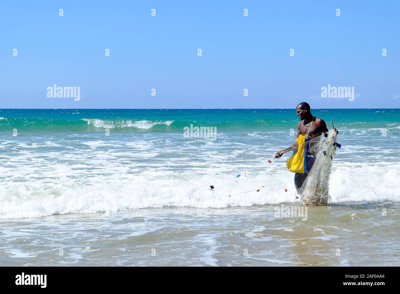African fisherman in shallow water with his fishing net Stock Photo - Alamy
