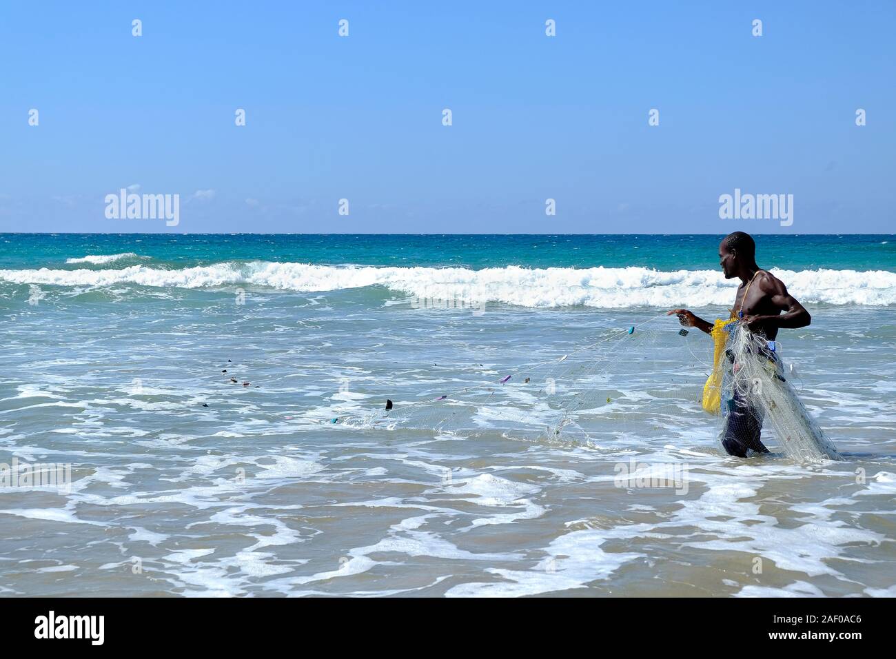 African fisherman in shallow water with his fishing net Stock Photo - Alamy
