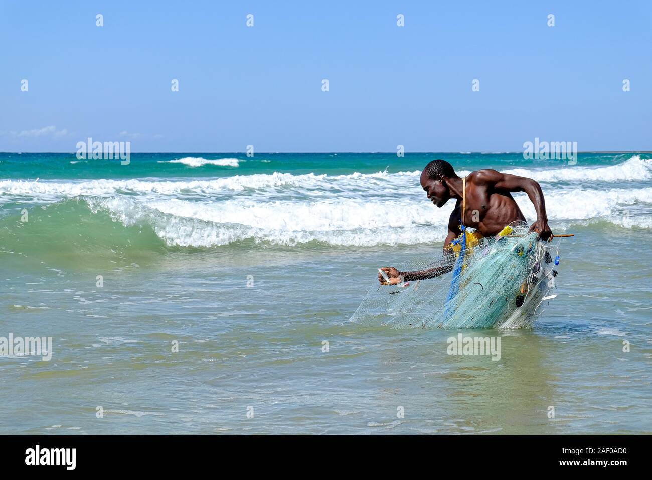 African fisherman in shallow water with his fishing net Stock Photo - Alamy