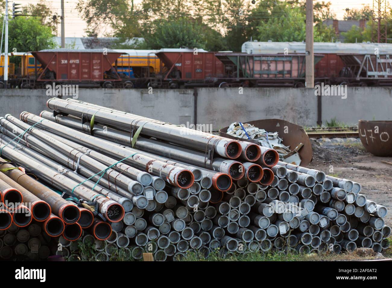 Metal rolling. Pipes folded in a railway warehouse are being prepared ...