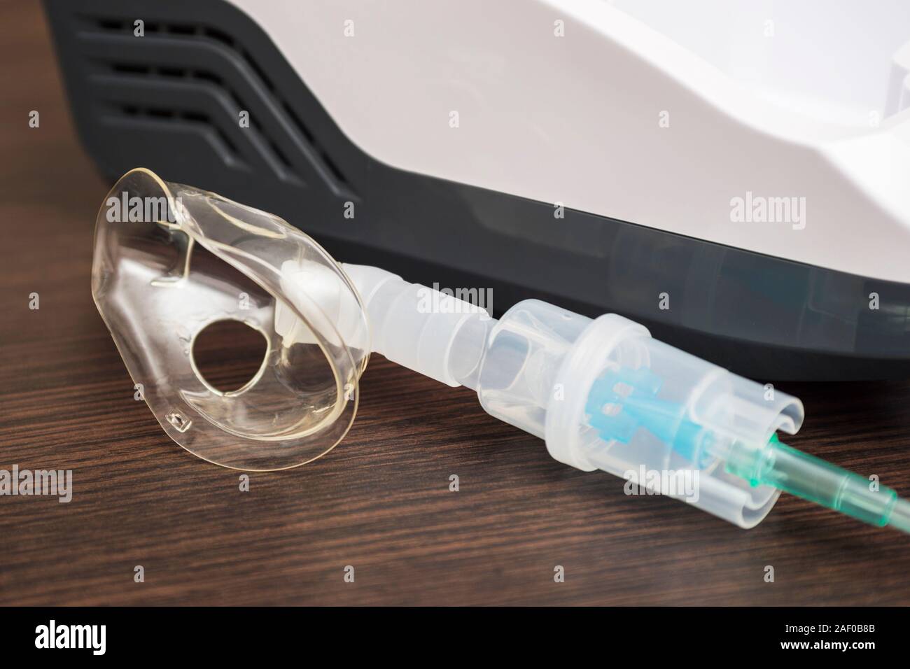 Medical equipment for inhalation, respiratory mask on wooden background ...