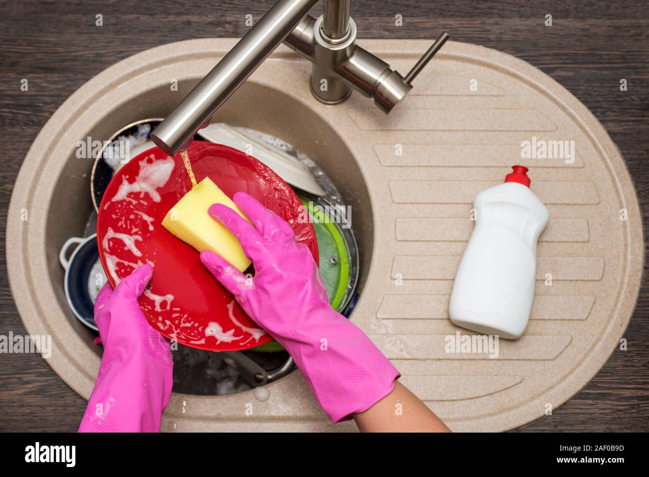 Woman washing dishes in the kitchen. Close up of woman hand. Housewife ...