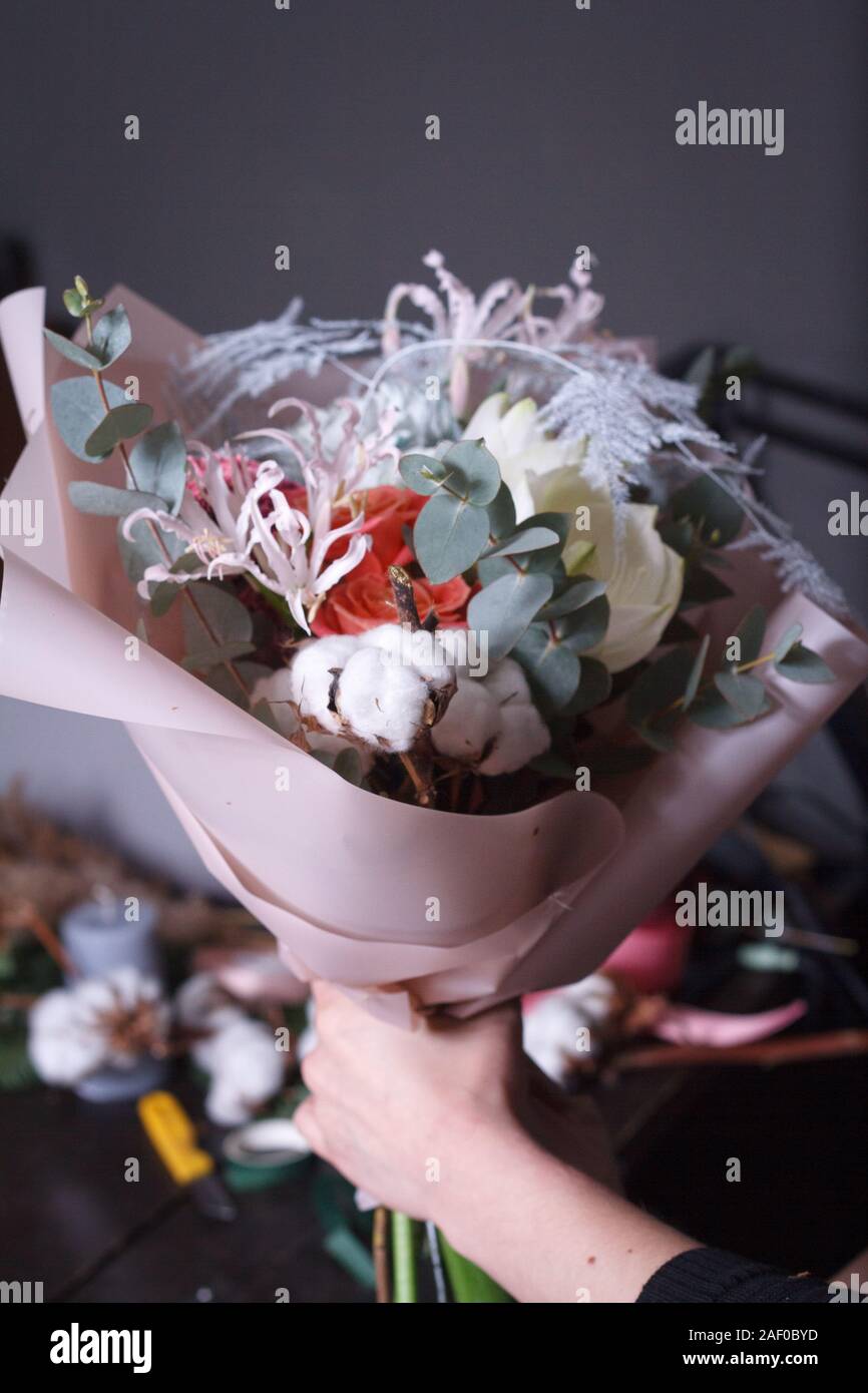Woman florist makes a bouquet to order, concept of own flower business, selective focus Stock ...