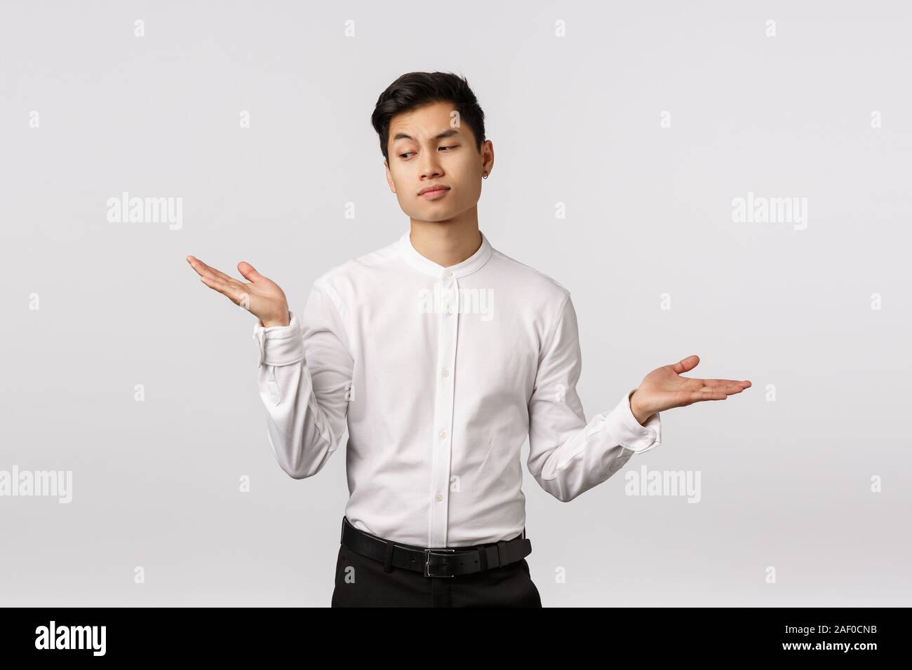 Unsure, skeptical stylish asian male entrepreneur, office worker making ...