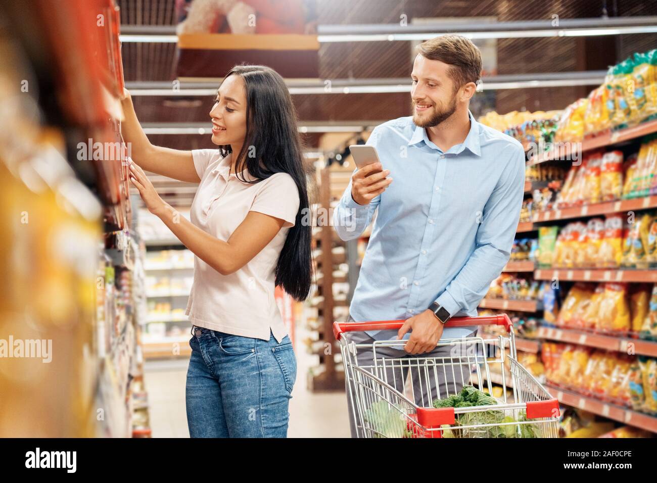 Young family choosing products in hi-res stock photography and images ...