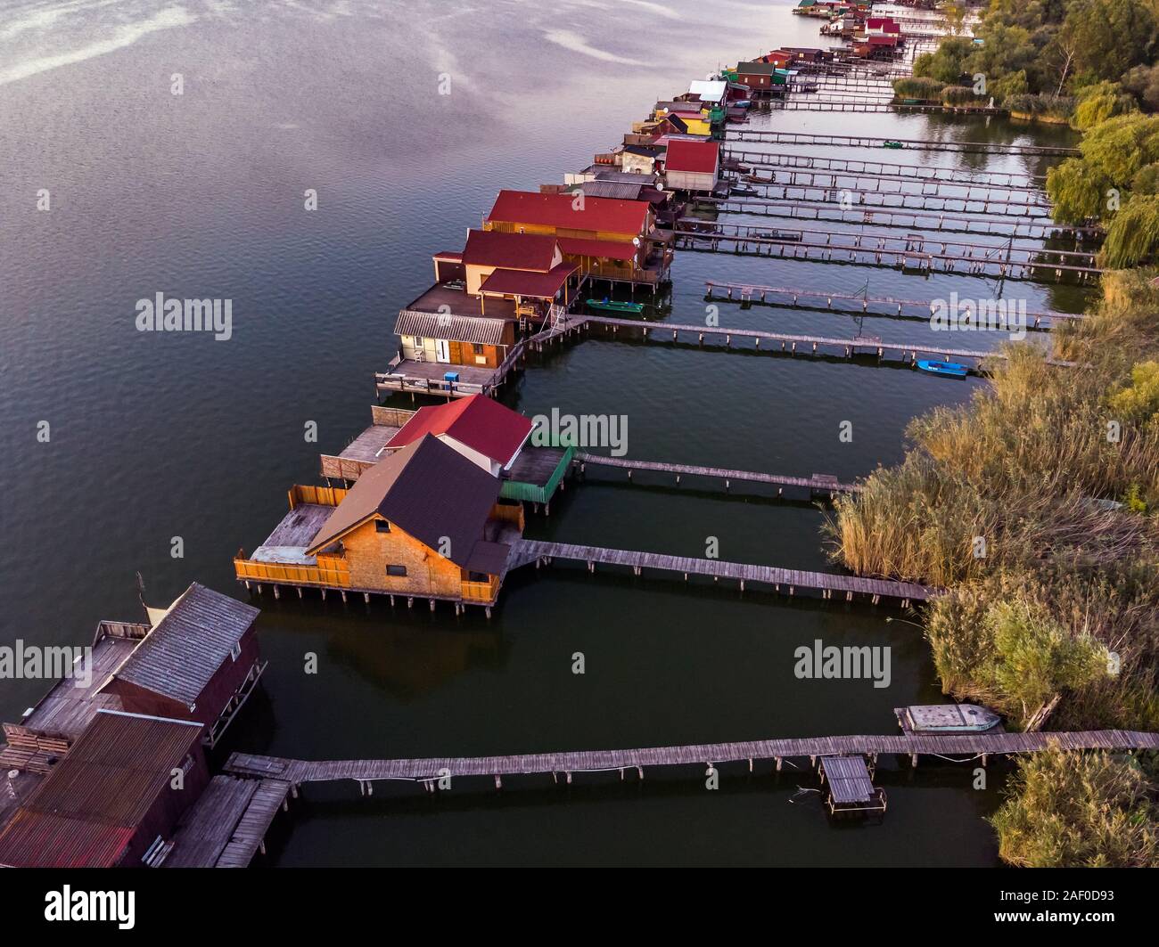Floating village Bokodi to in Hungary at sunset. These houses belong to ...