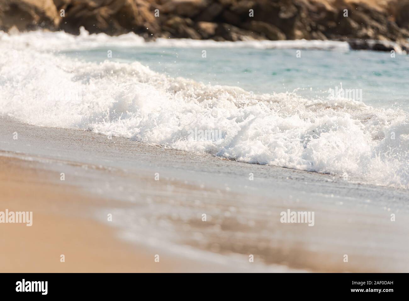 Mediterranean surf. Small waves roll on the shore. Sea foam on the ...