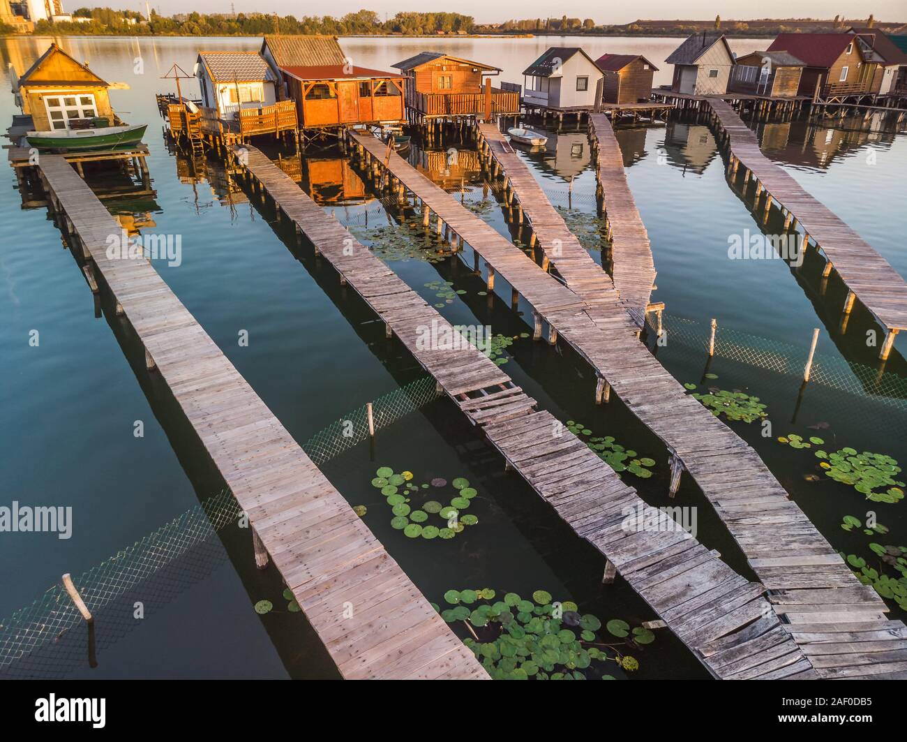 Floating village Bokodi to in Hungary at sunsrise. These houses belong ...