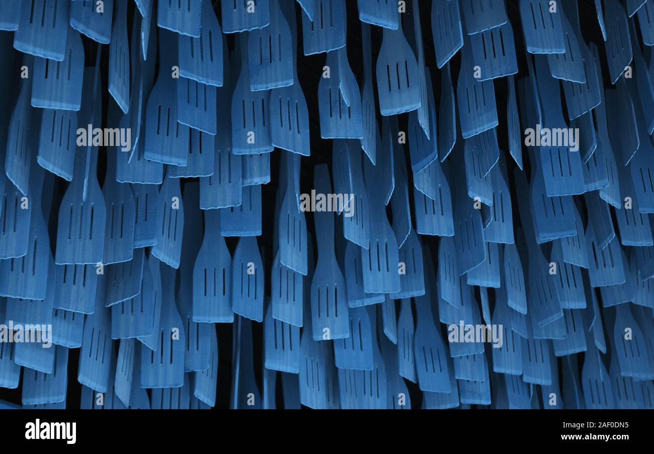 Blue Wooden spoons hanging from the sealing. Cooking spoons pattern ...