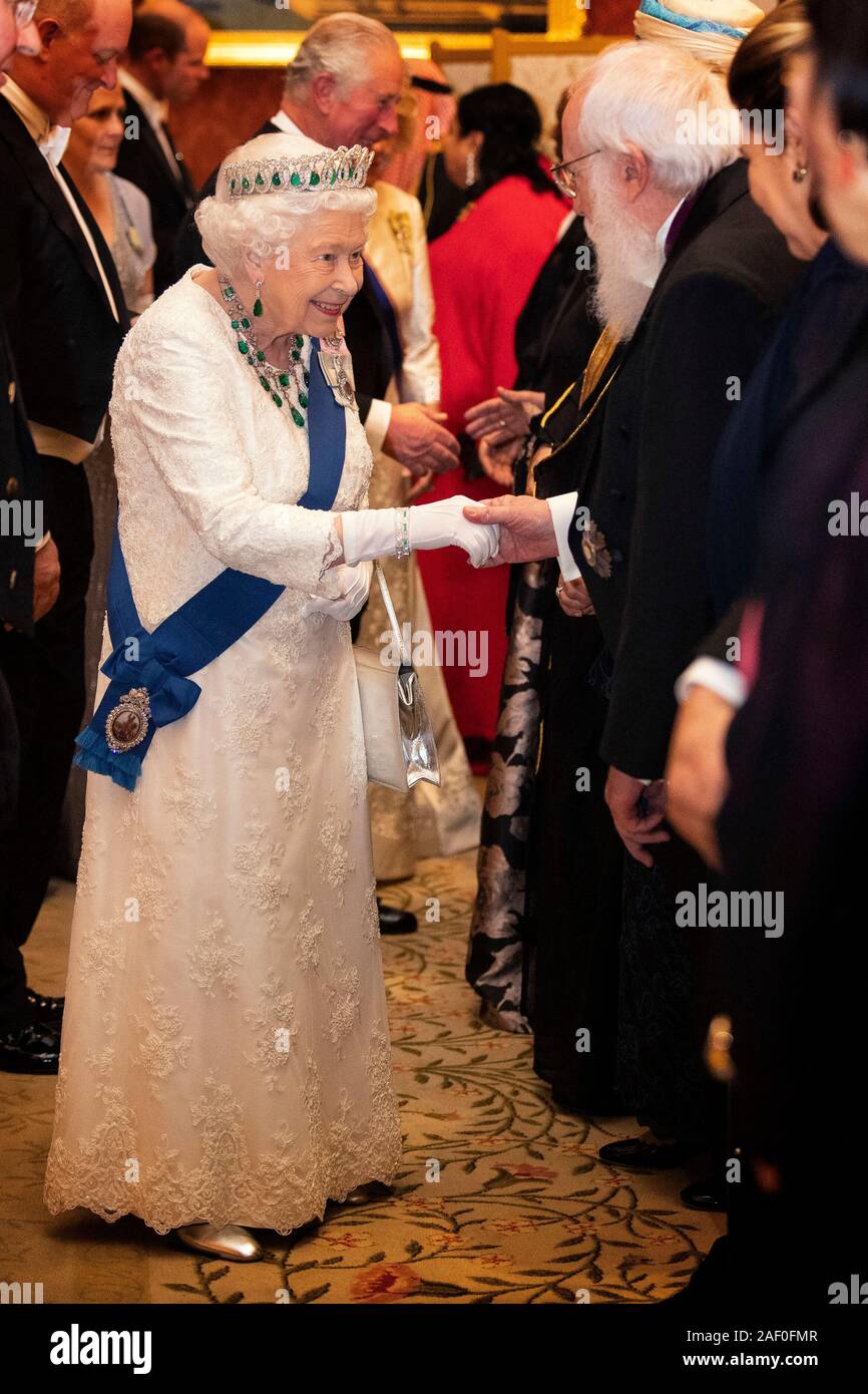 Queen Elizabeth II talks to guests at an evening reception for members ...