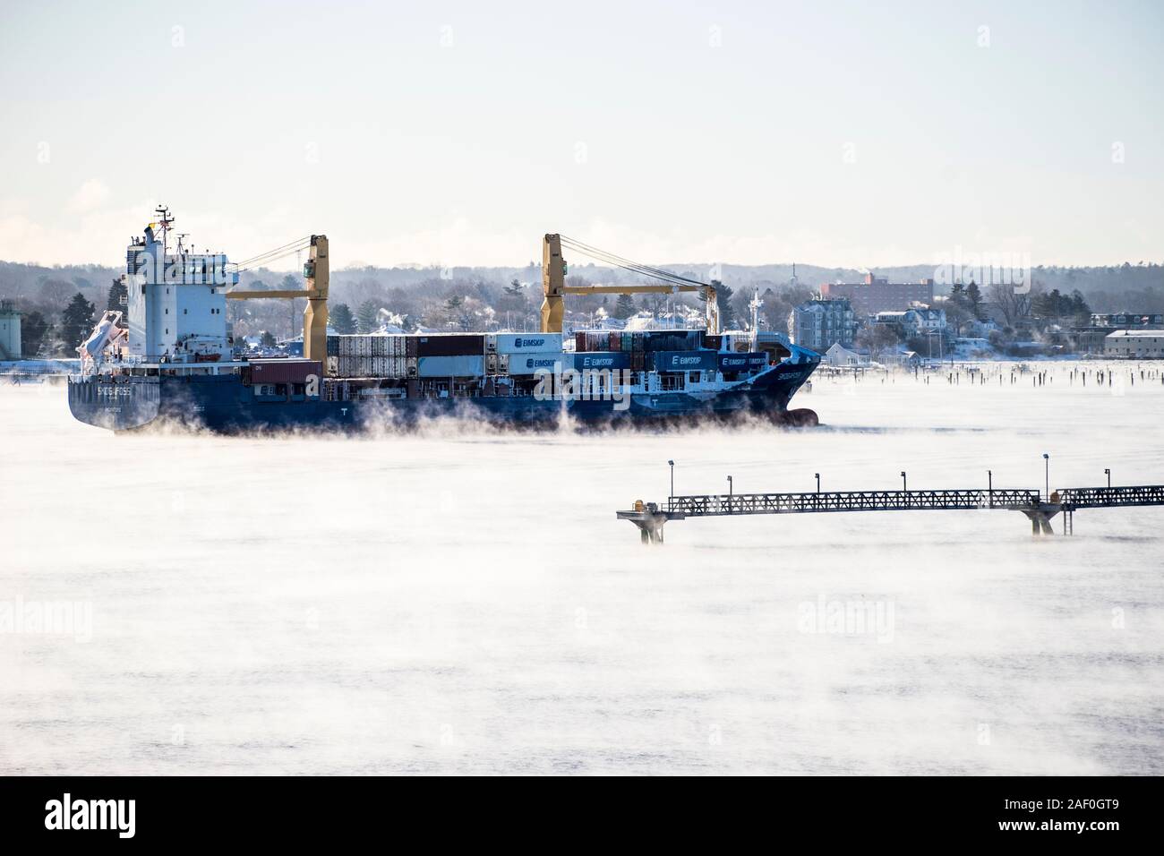 Ship coming into port through sea smoke Stock Photo - Alamy