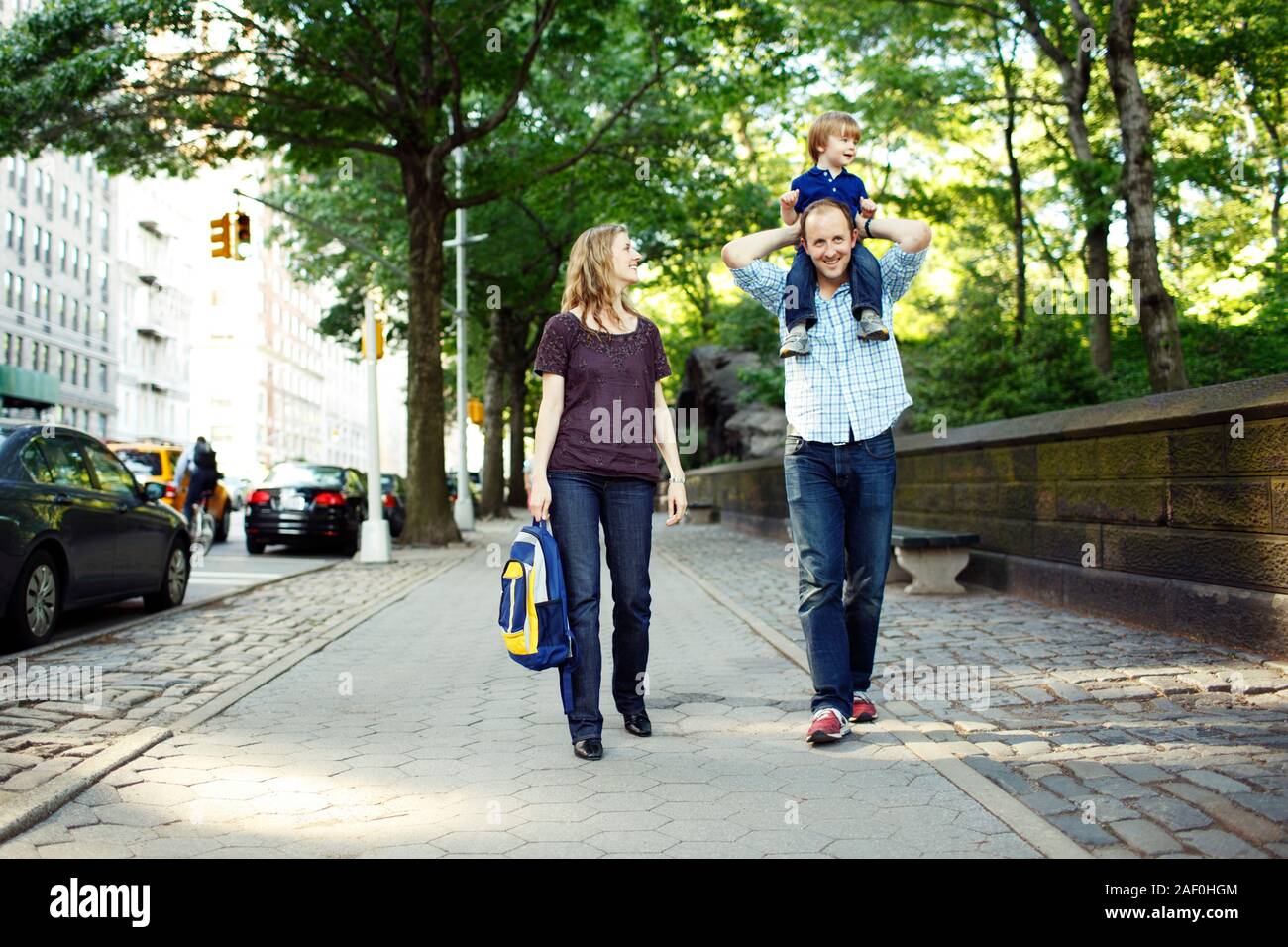 Parents walking son to preschool or daycare Stock Photo - Alamy