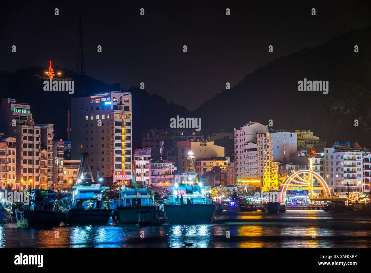 CAT BA, VIETNAM - April 12, 2019 Fishing Boats and City Center at night ...