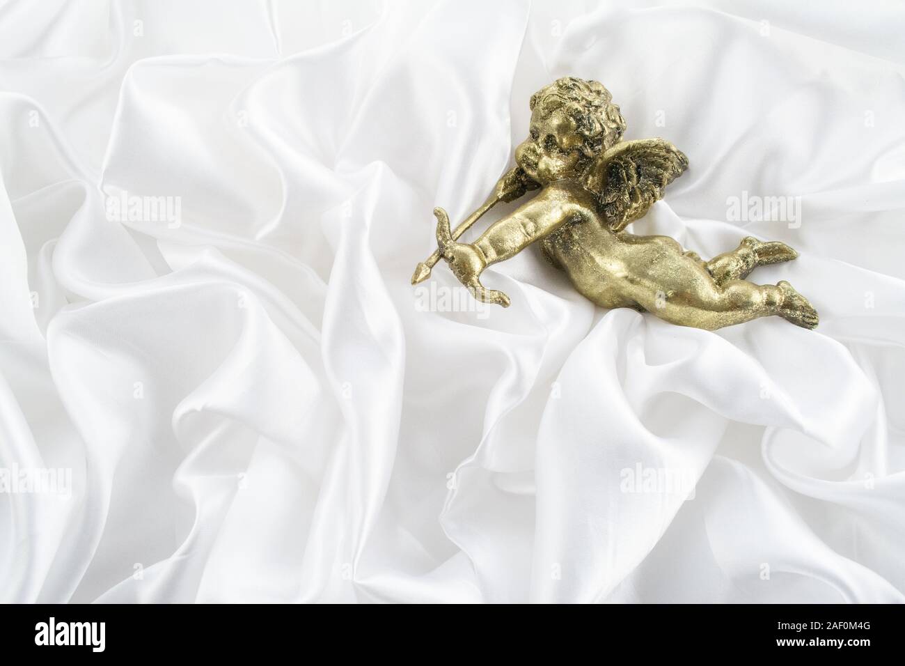 cupidon with arrow on cream,white background Stock Photo - Alamy