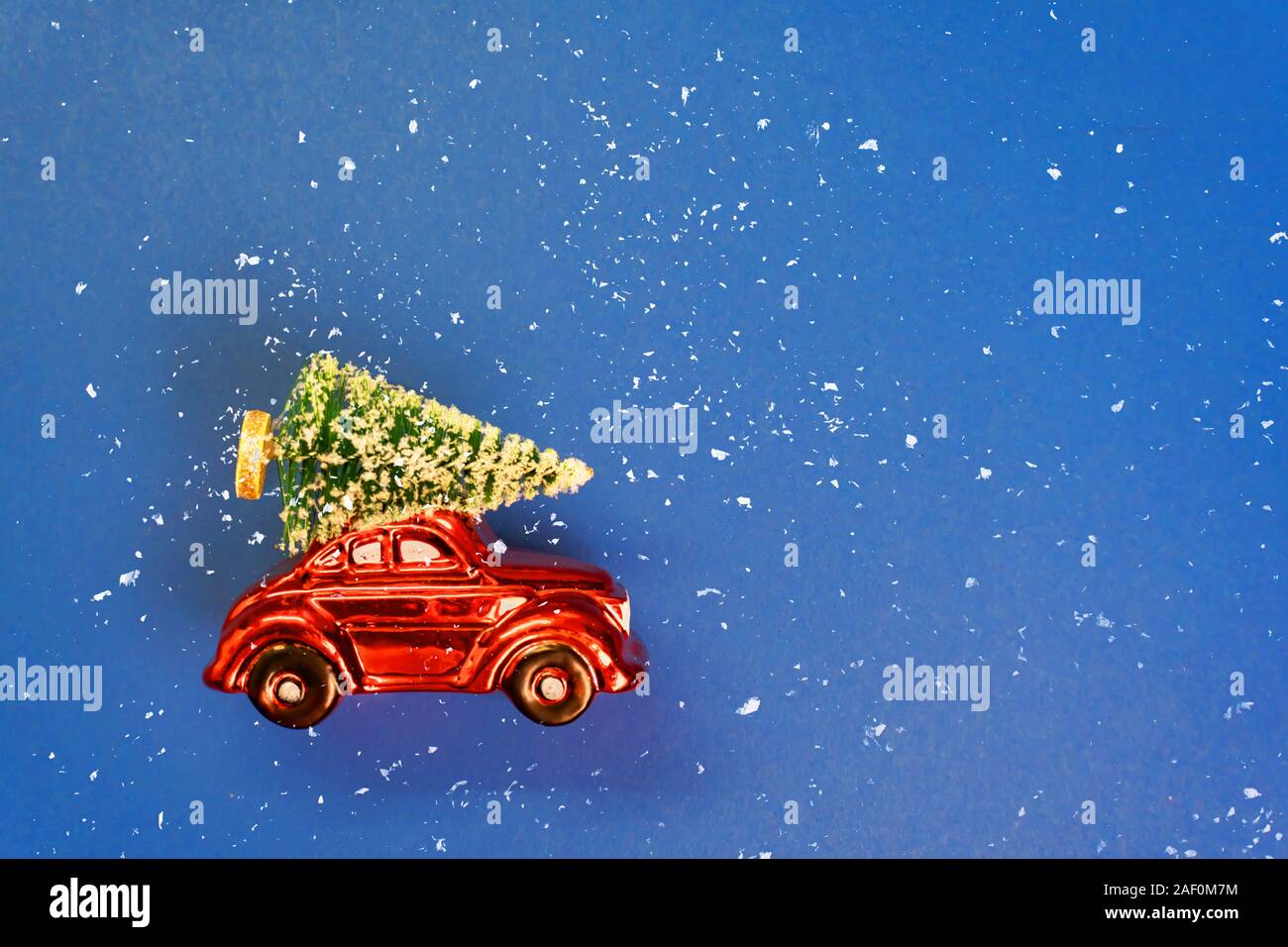 Christmas car with tree on the roof on blue background Stock Photo - Alamy