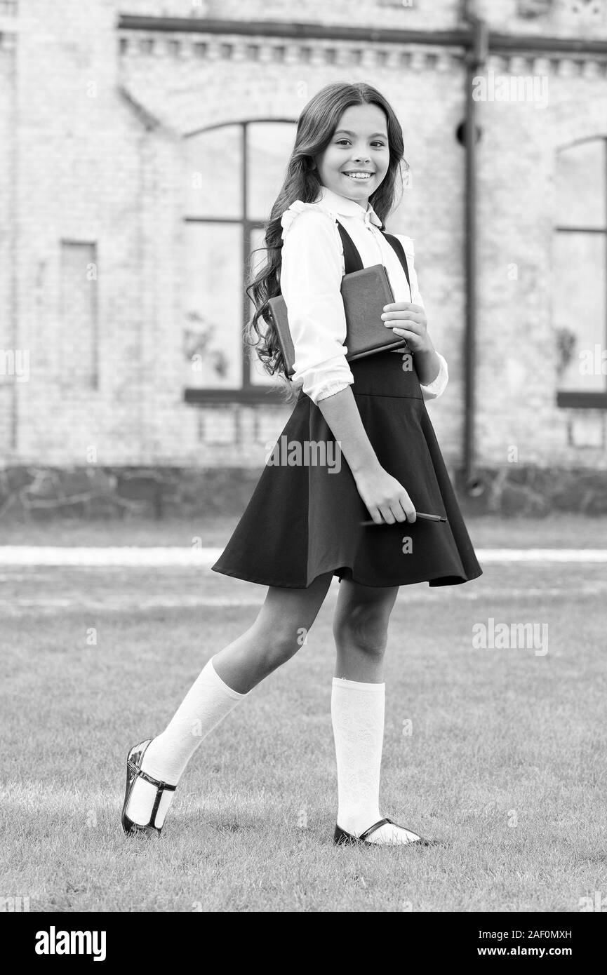 Demanded knowledge. Cute smiling child hold book. Adorable little girl ...