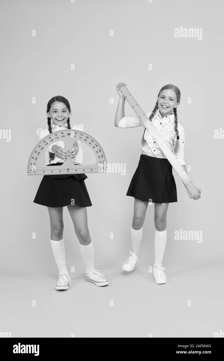 School students study geometry. Pupil school girls big rulers. School ...