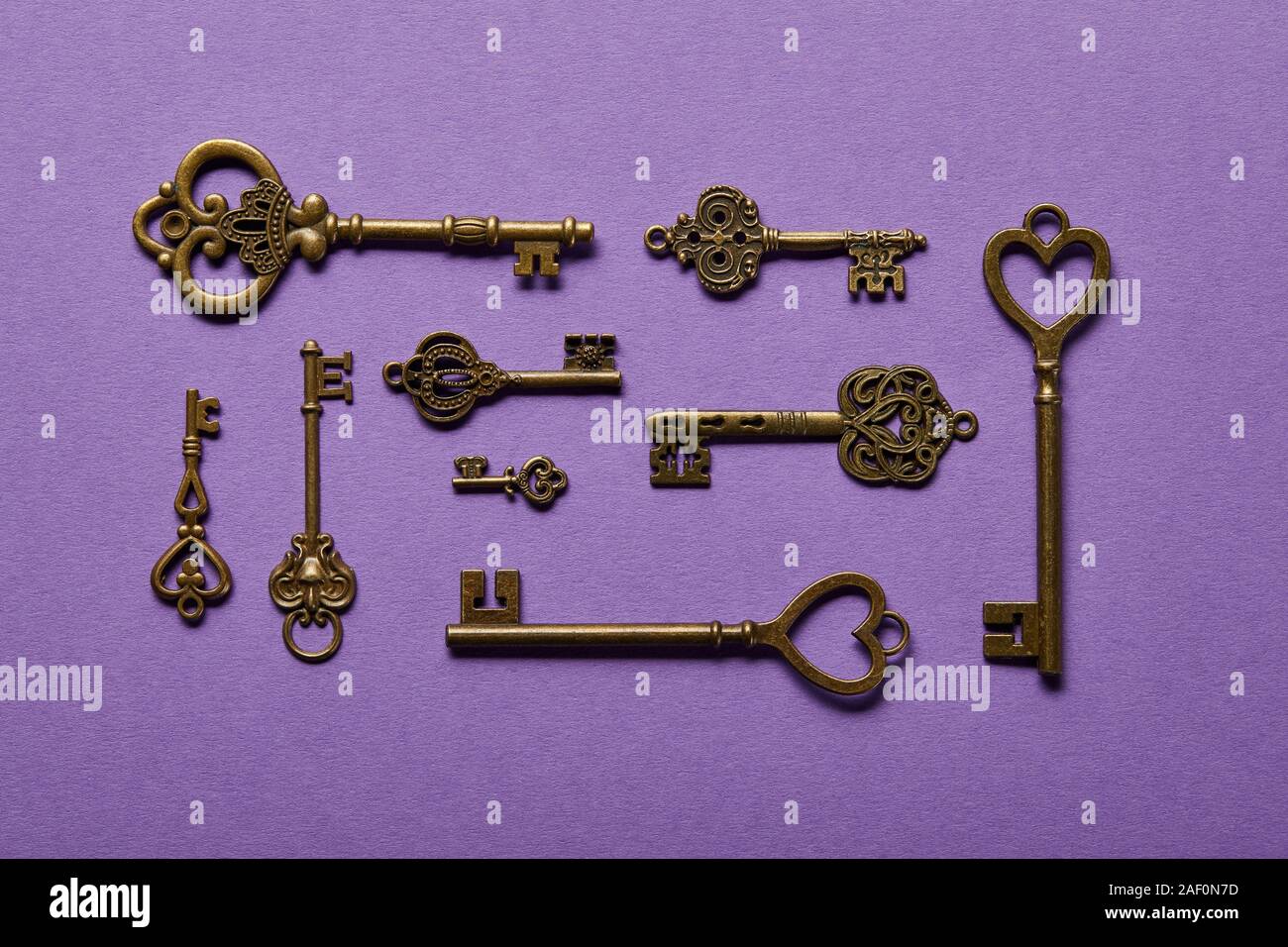 top view of vintage keys on violet background Stock Photo - Alamy