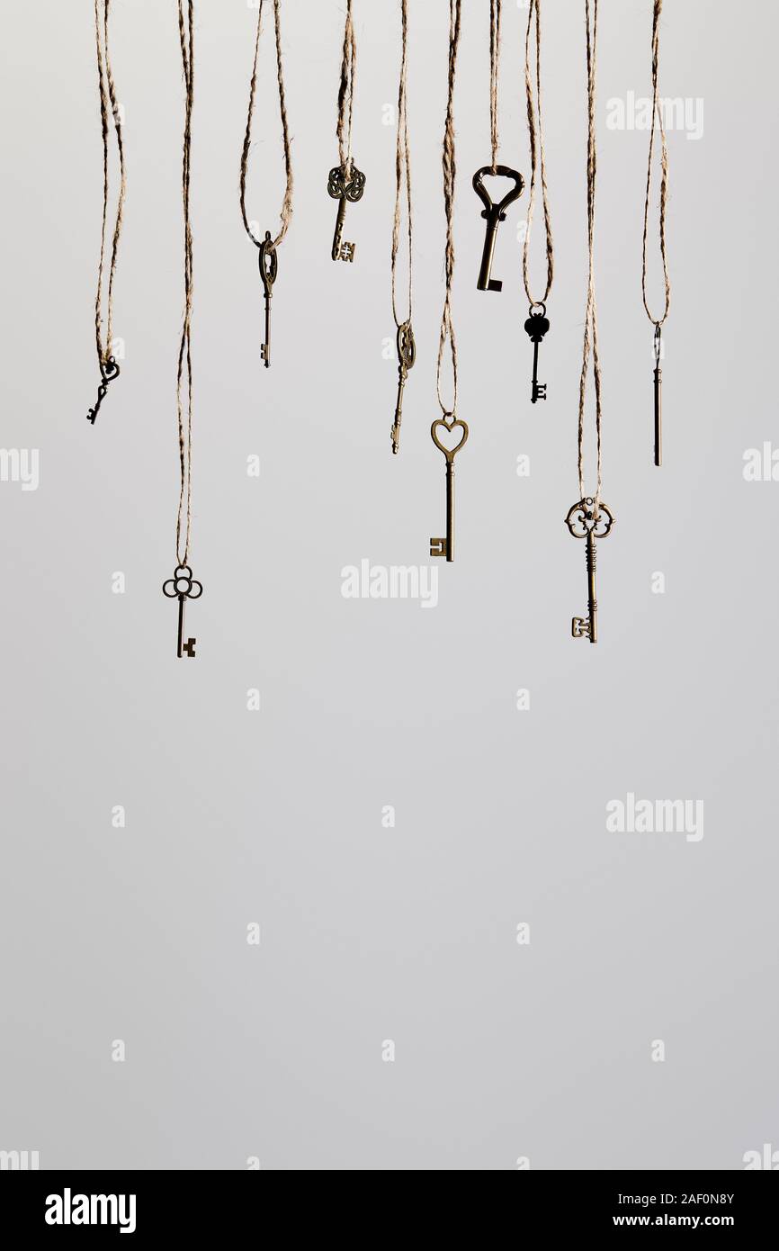 vintage keys hanging on ropes isolated on white Stock Photo - Alamy