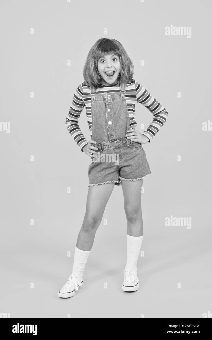 Cosplay outfit. Otaku girl in wig smiling on yellow background. Happy ...