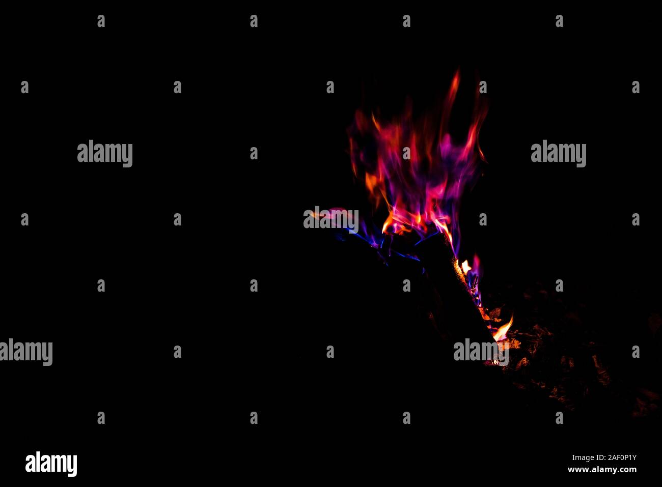 pink and purple flame in bonfire isolated on black Stock Photo - Alamy