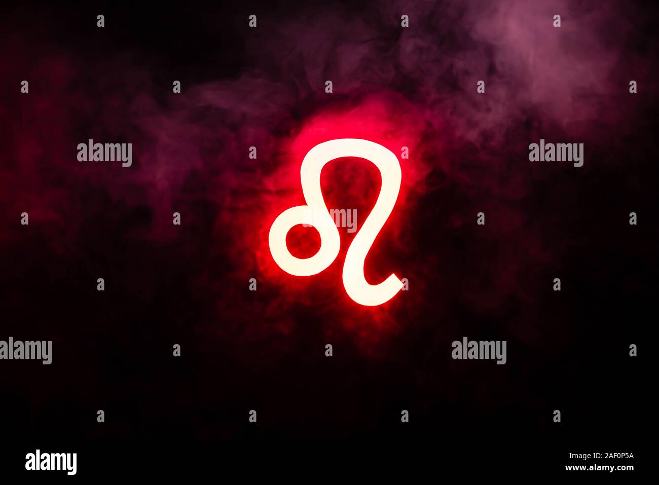 red illuminated Leo zodiac sign with smoke on background Stock Photo ...