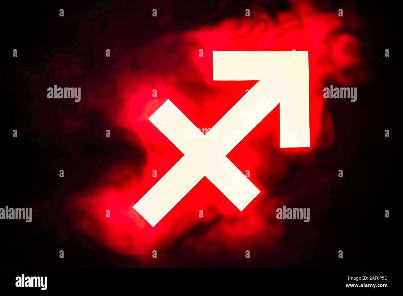 red illuminated Sagittarius zodiac sign with smoke on background Stock ...