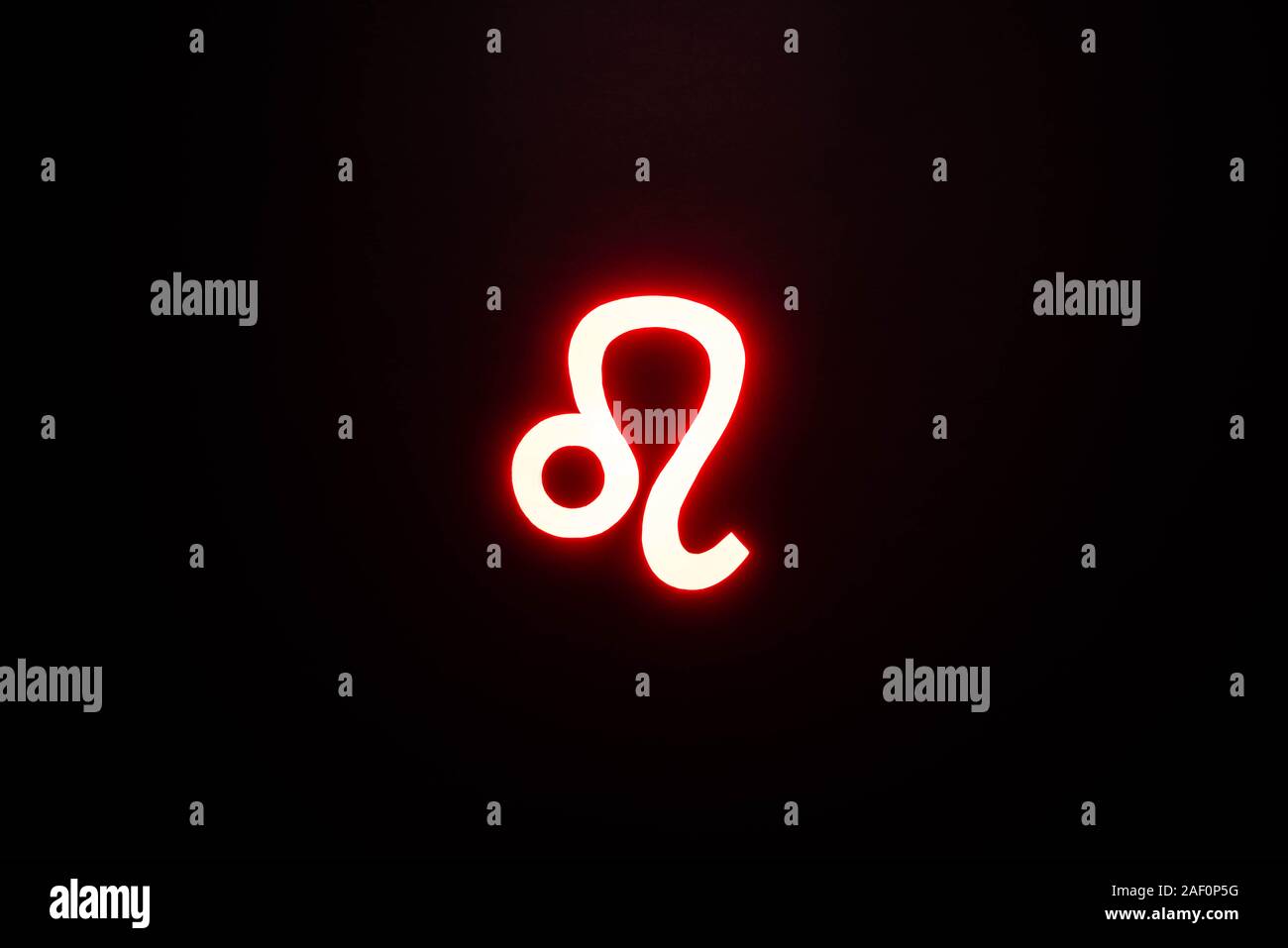 red illuminated Leo zodiac sign isolated on black Stock Photo - Alamy