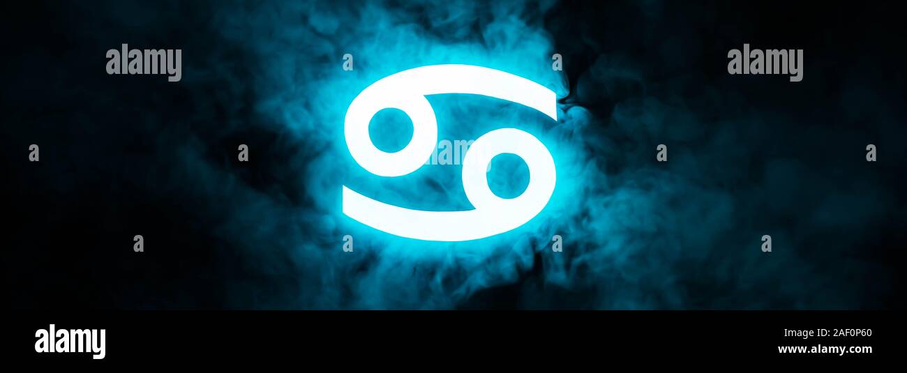blue illuminated Cancer zodiac sign with smoke on background, panoramic ...
