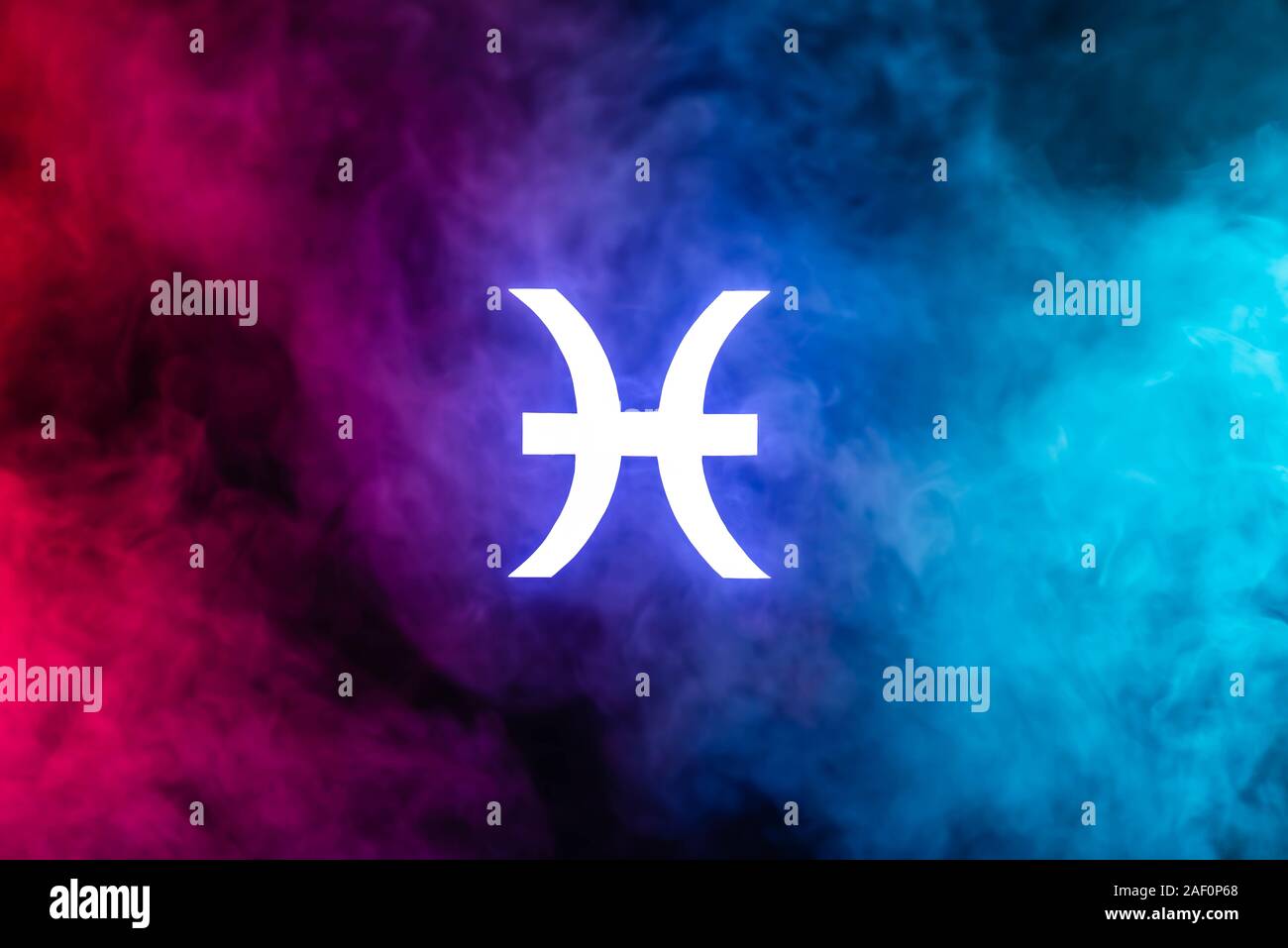 blue illuminated Pisces zodiac sign with colorful smoke on background ...