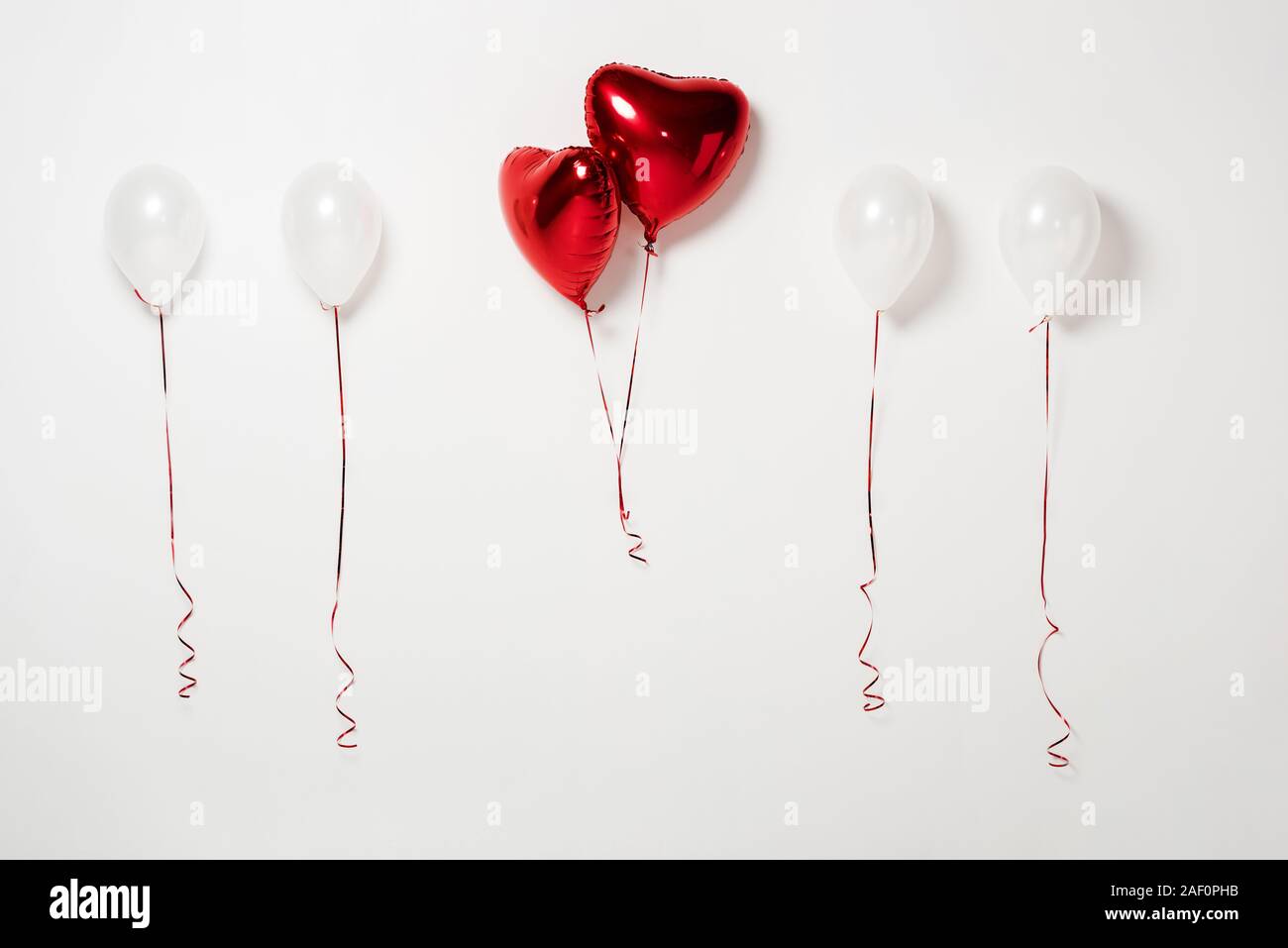 shiny and red party balloons on white Stock Photo - Alamy