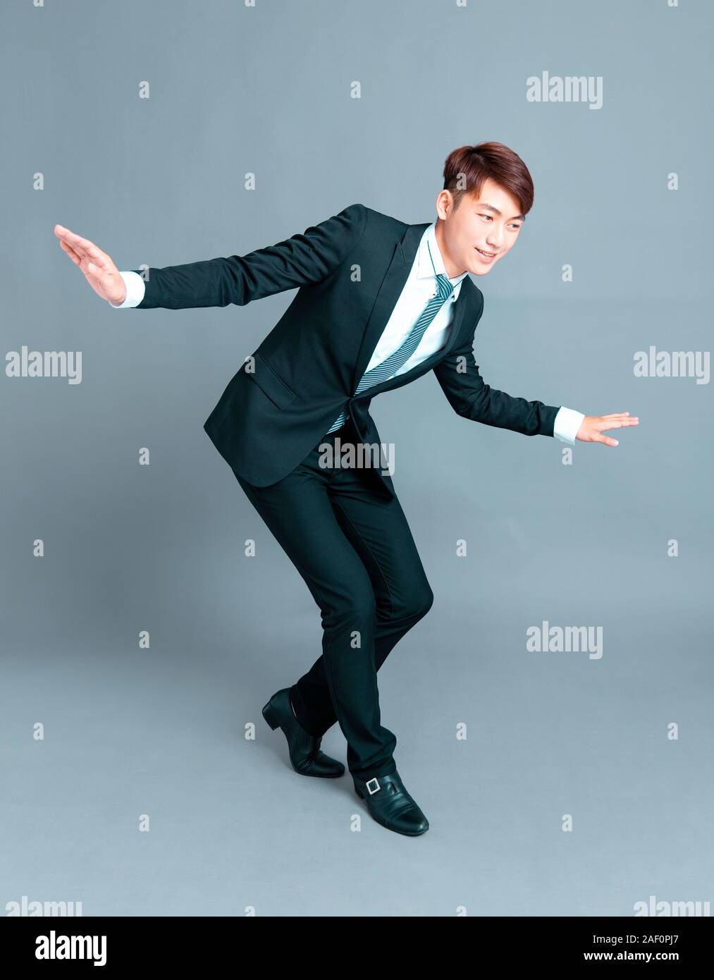 Business man walking carefully, try to balance Stock Photo - Alamy