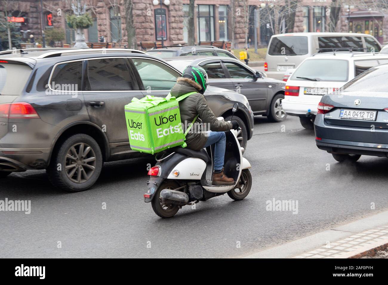 Kiev, Ukraine - February 20, 2019: Food delivery man drive scooter with ...