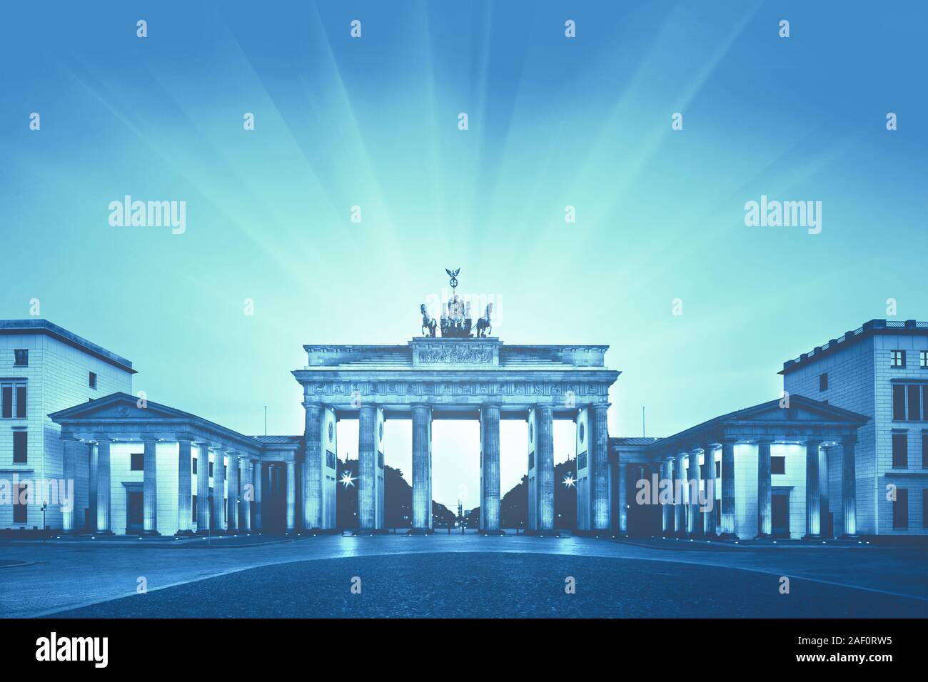 Illuminated Brandenburg Gate (Brandenburger Tor) in Berlin, Germany, at night. Monochrome ...
