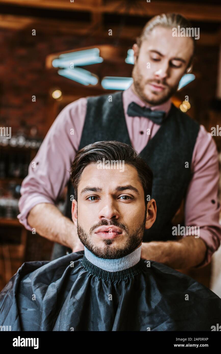 selective focus barber fixing collar around neck of man Stock Photo - Alamy