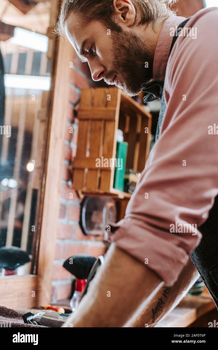 side view of handsome barber standing in barbershop Stock Photo - Alamy