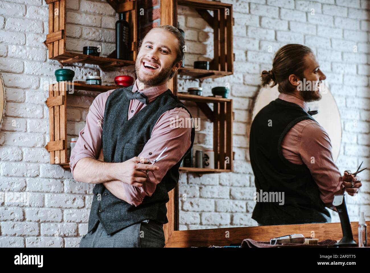 happy barber laughing while holding scissors Stock Photo - Alamy