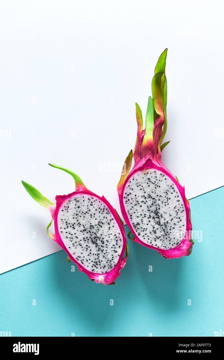 Creative flat layout with dragonfruit (pitaya or pitahaya) on two tone ...