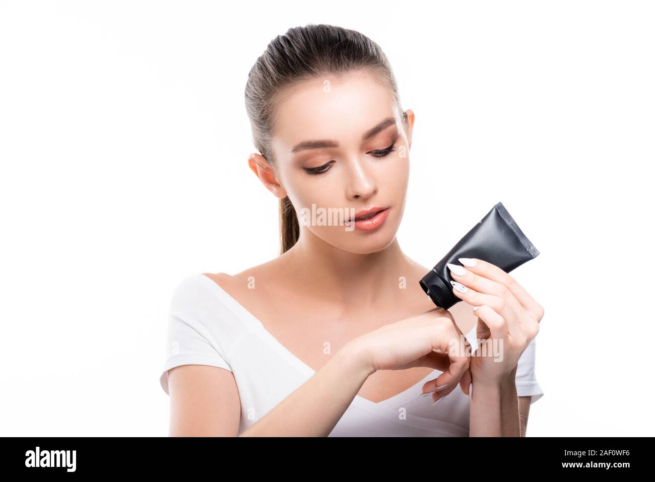 attractive young woman applying hand cream isolated on white Stock ...