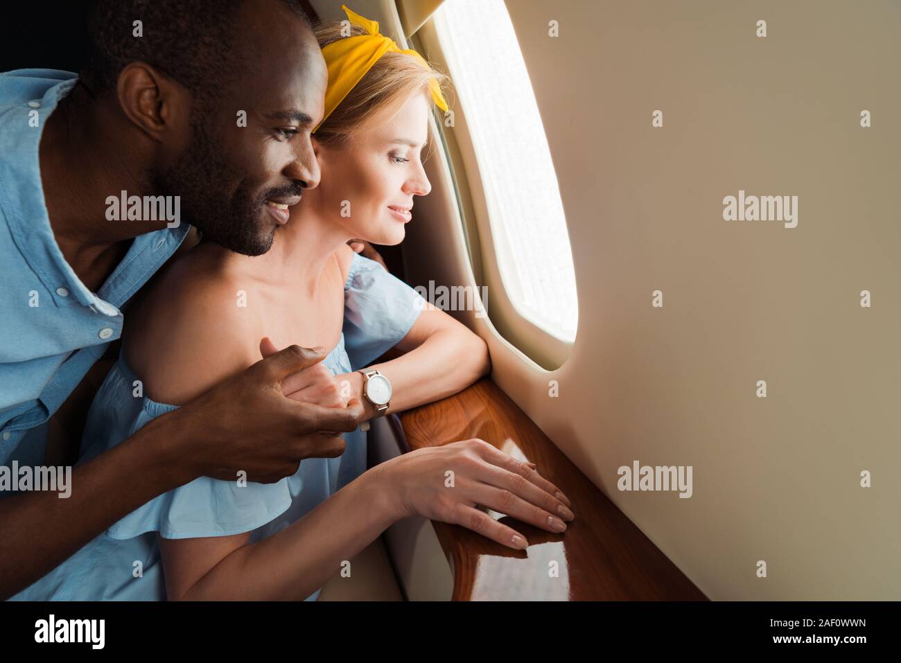 happy african american man and cheerful woman looking at airplane ... happy african american man and cheerful woman looking at airplane ...