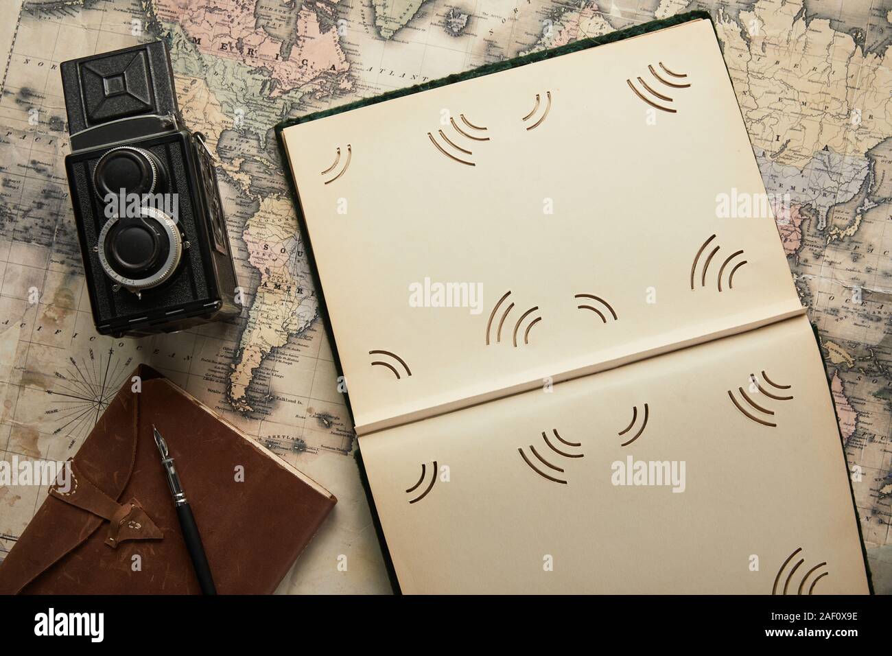 top view of vintage camera, notepad with fountain pen, empty photo ...