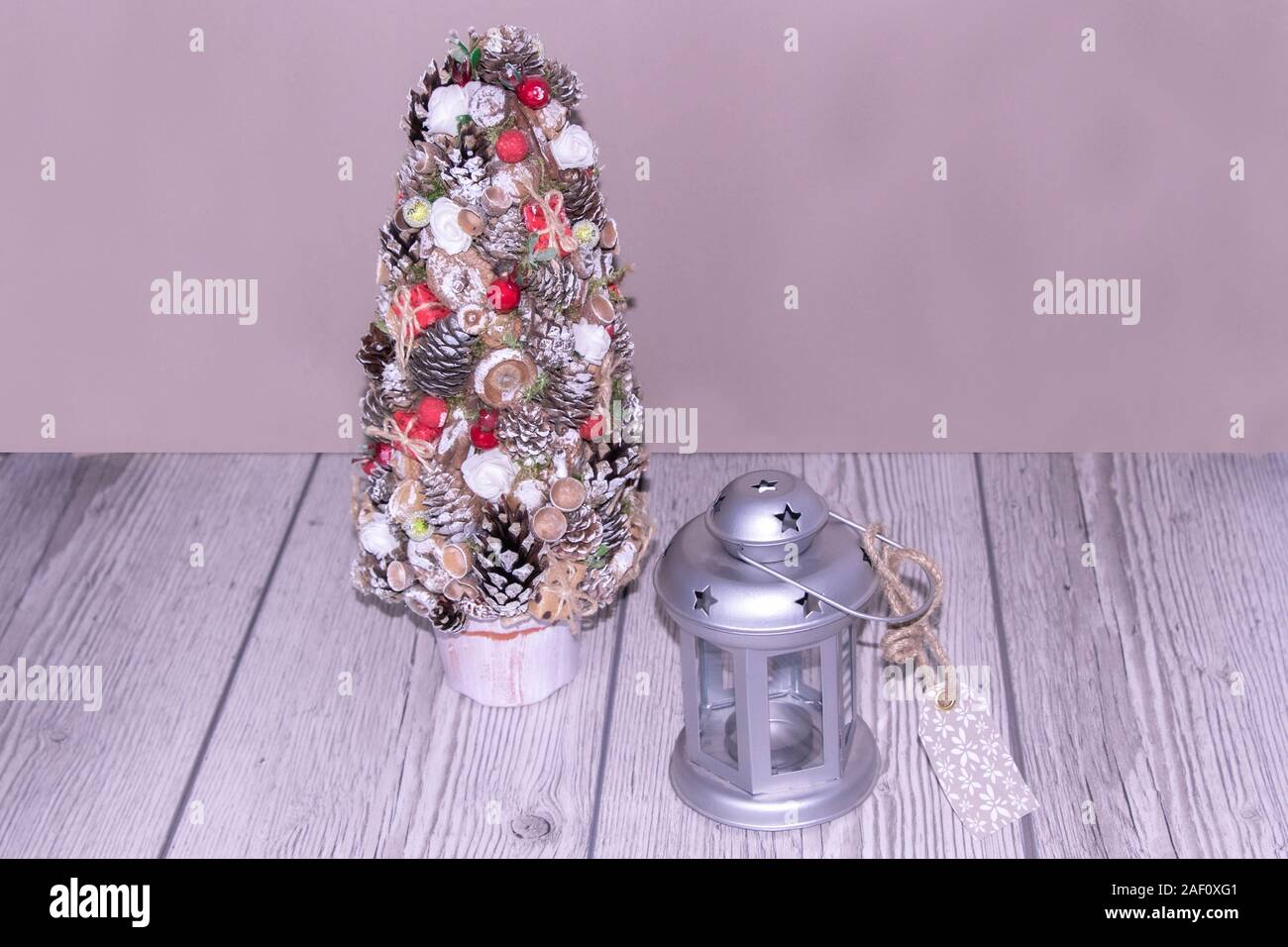 Handmade Christmas tree with cones and acorns along with a flashlight ...