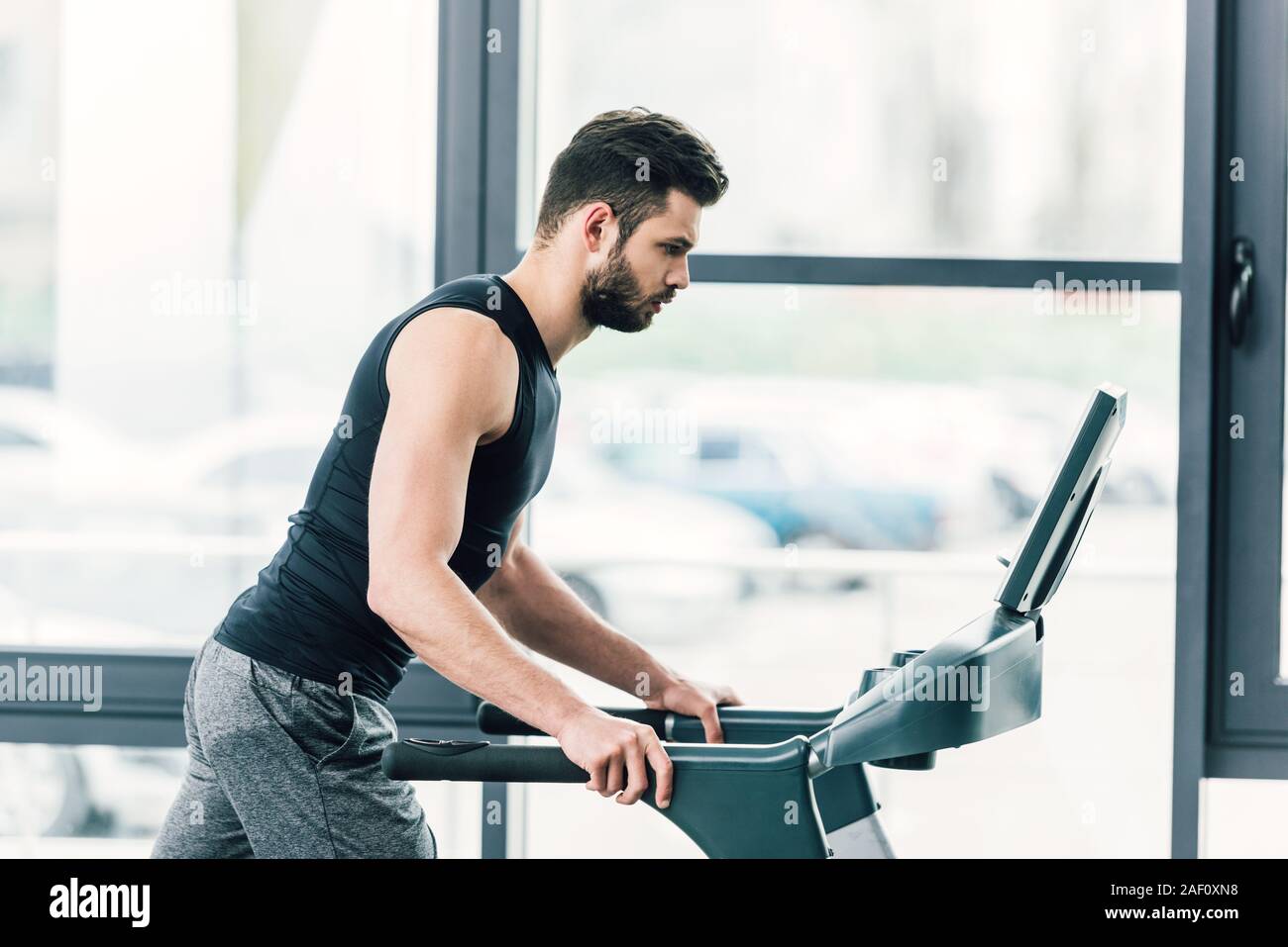 handsome sportsman running on treadmill at sports center Stock Photo ...