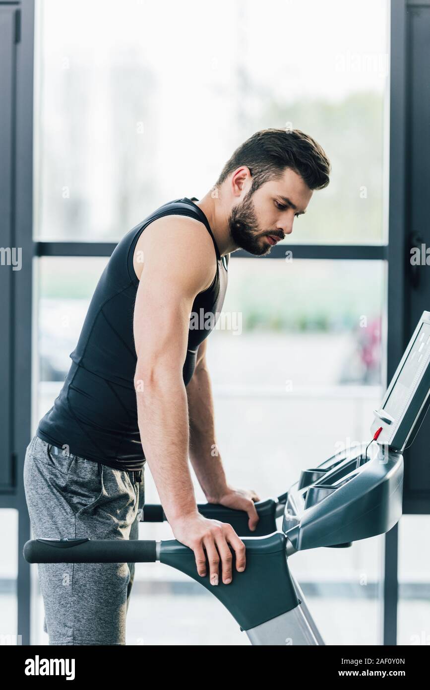 handsome sportsman training on treadmill at sports center Stock Photo ...