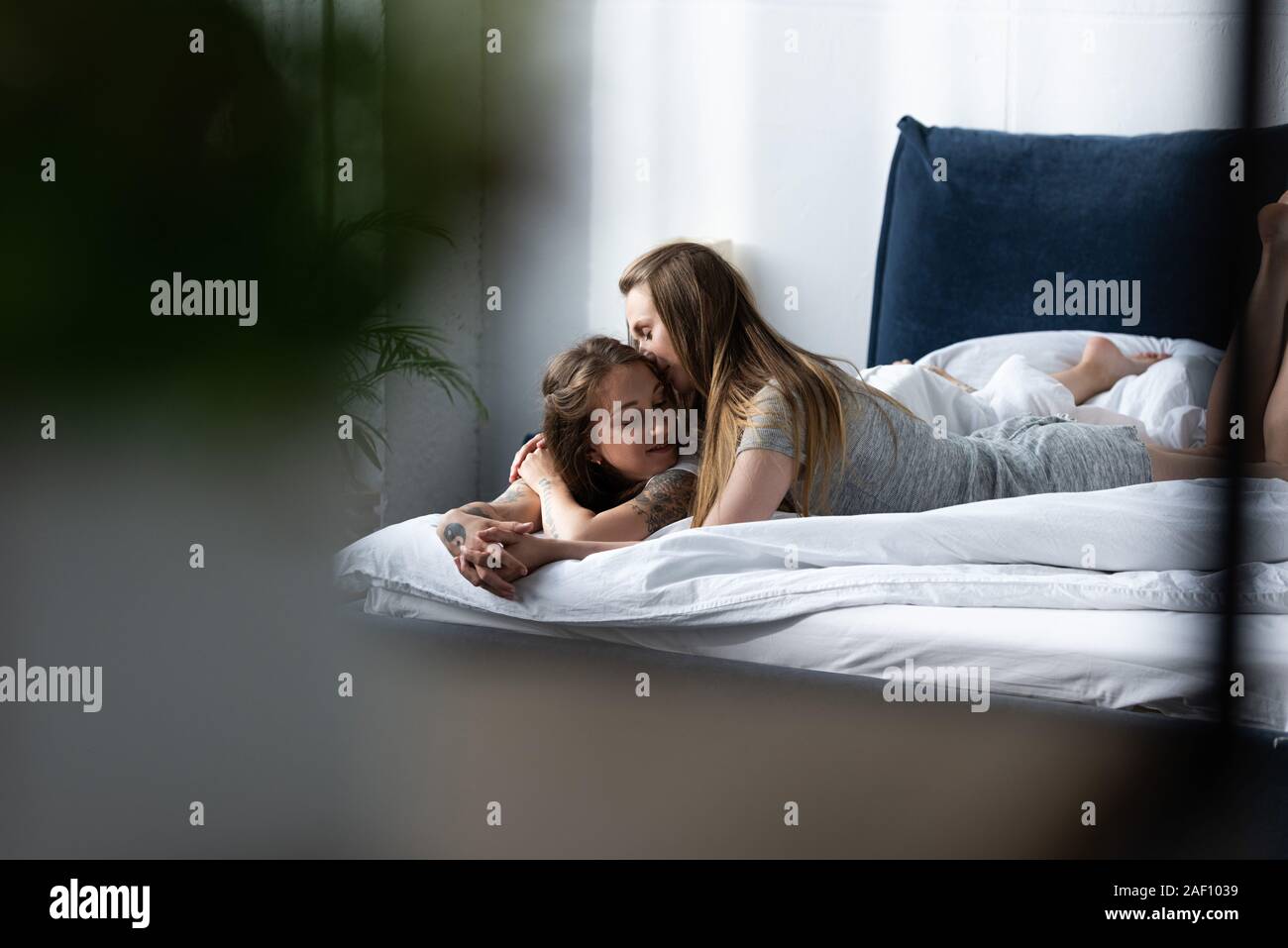 Selective Focus Of Two Lesbians Holding Hands While Lying On Bed In 4066